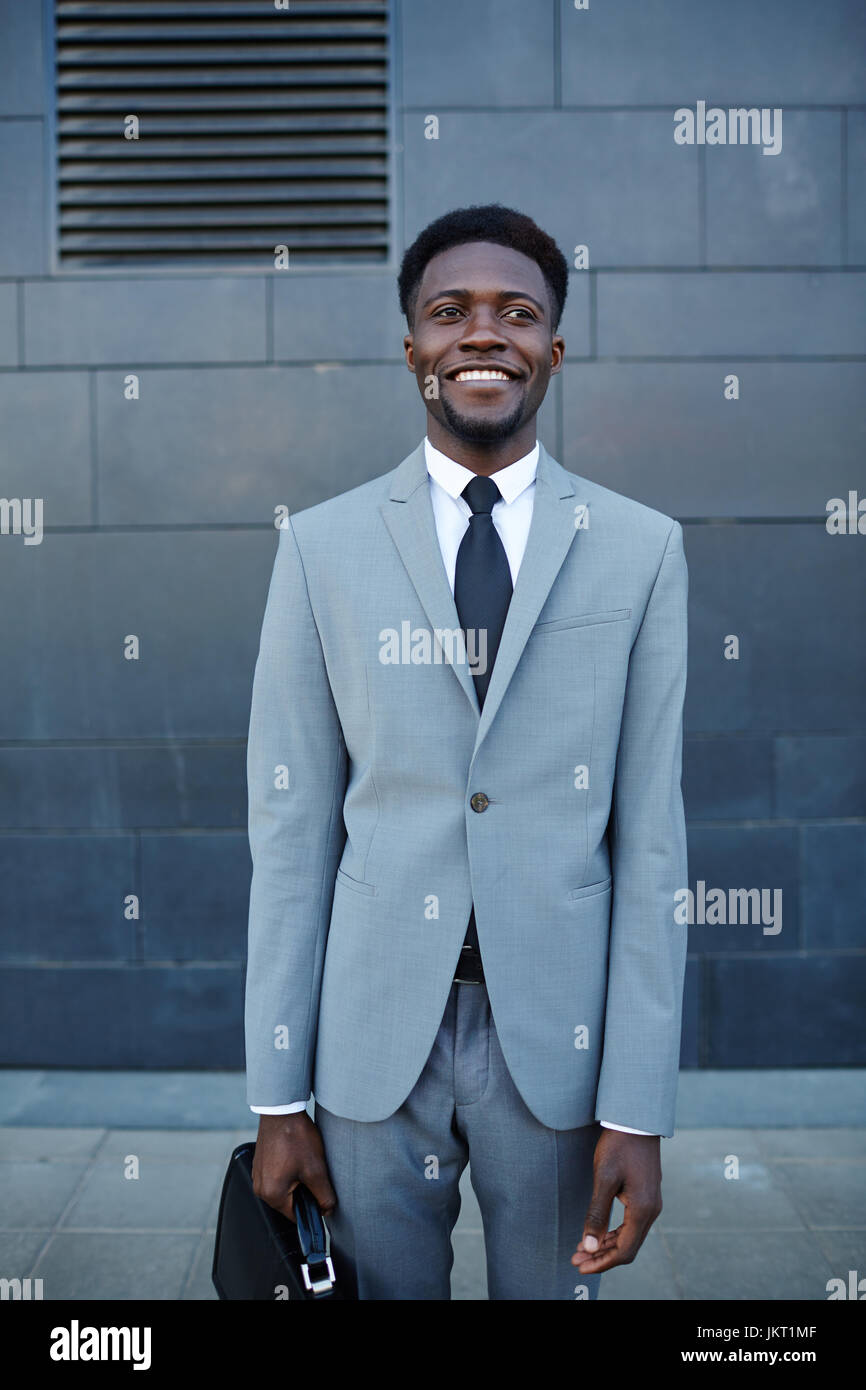 Happy young businessman in suit and tie Stock Photo - Alamy