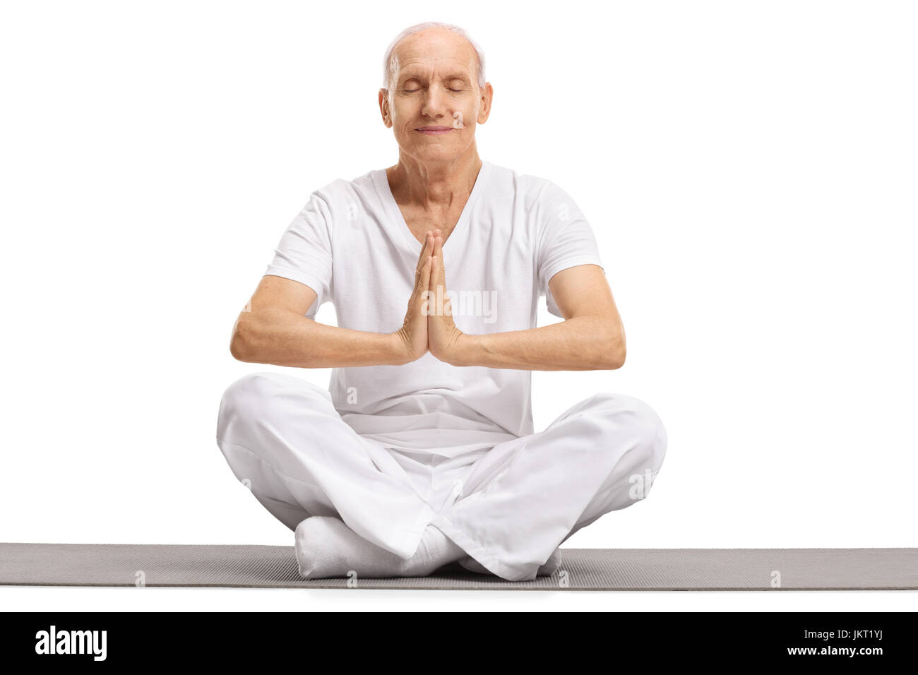 Senior meditating on an exercise mat isolated on white background Stock ...
