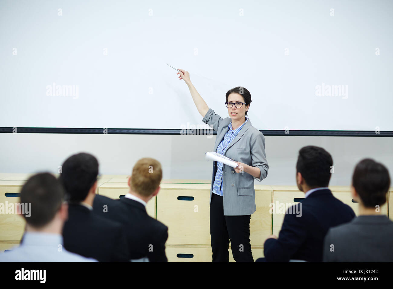 Business expert explaining new trends on whiteboard Stock Photo - Alamy