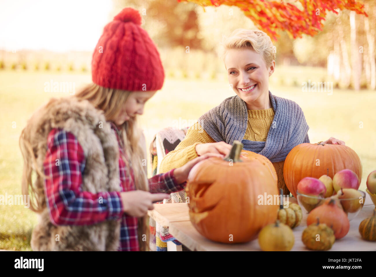 My capable girl cutting Halloween's pumpkin Stock Photo - Alamy