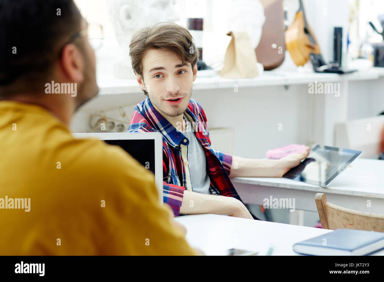 Two guys discussing assignment while preparing for lesson Stock Photo ...
