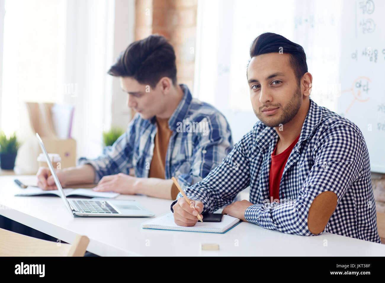 Two groupmates getting ready for seminar or lesson Stock Photo - Alamy