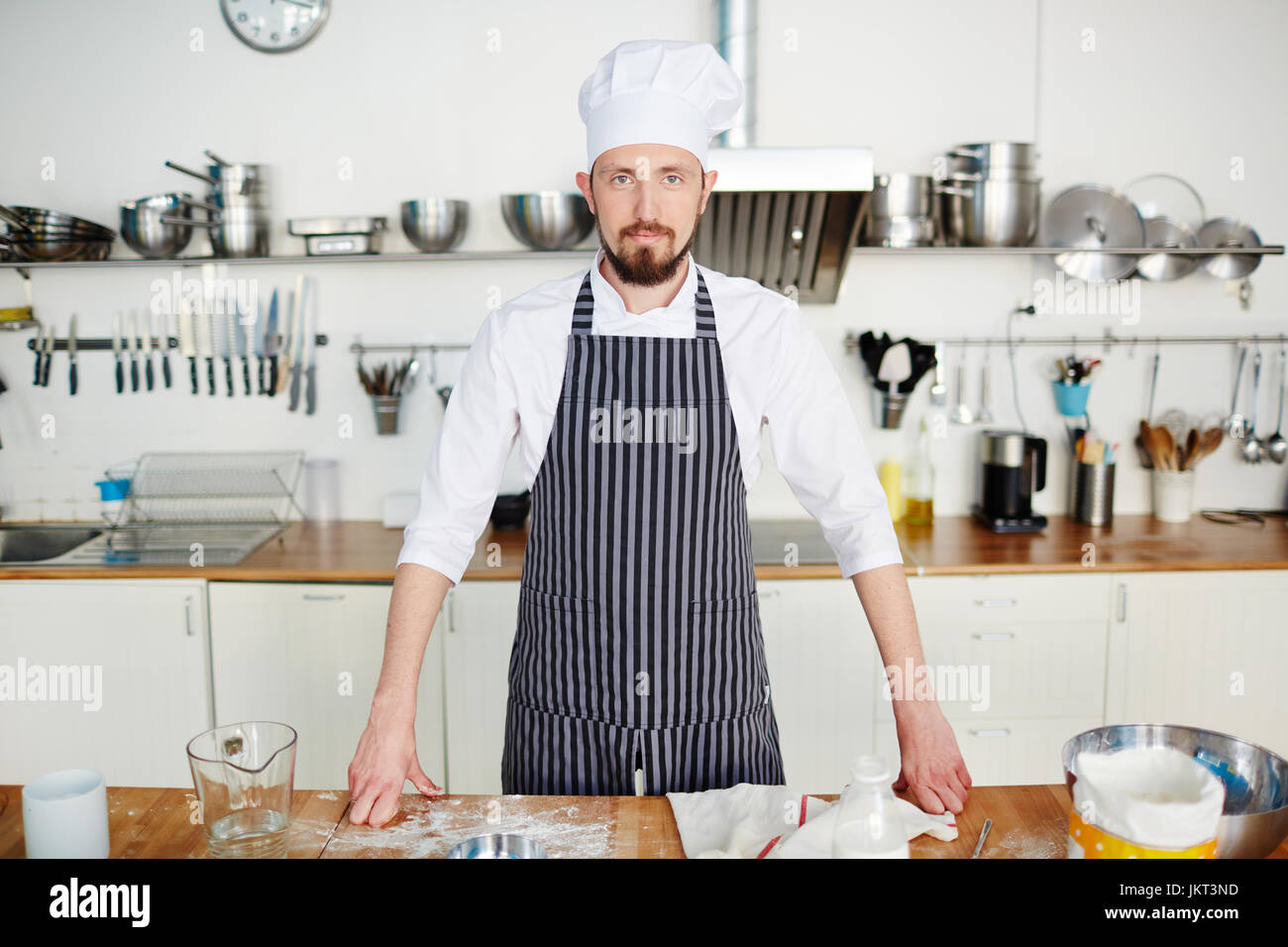 Pastry chef in uniform standing by his workplace Stock Photo - Alamy