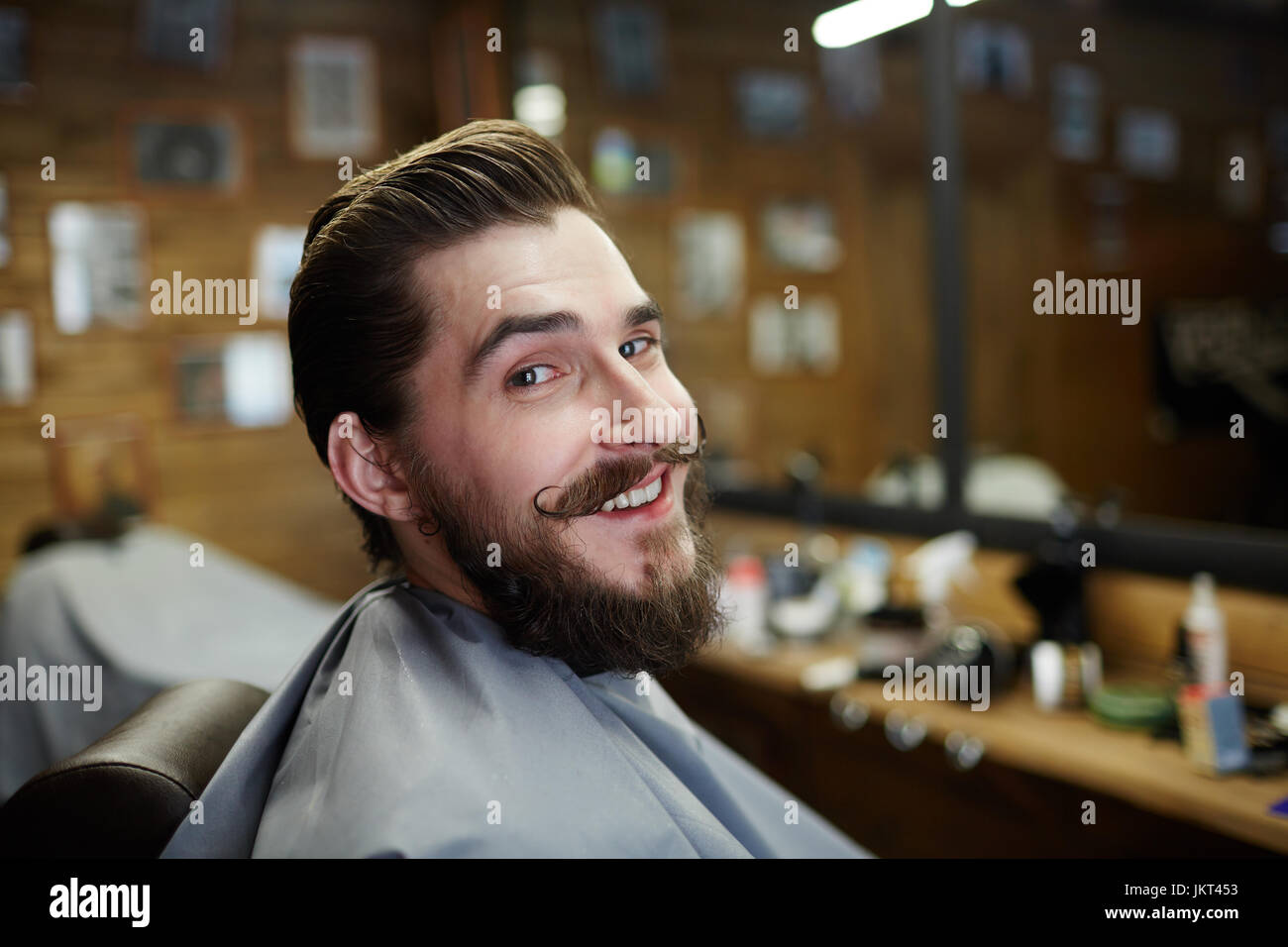 Smiling man with neat hairstyle looking at camera Stock Photo - Alamy