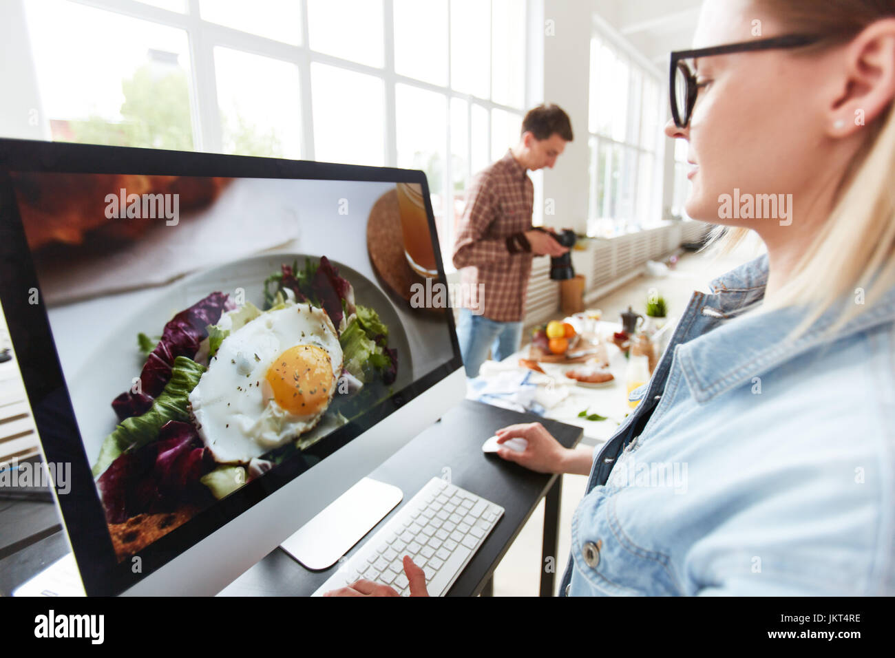 Professional food designer sitting in front of computer monitor in ...