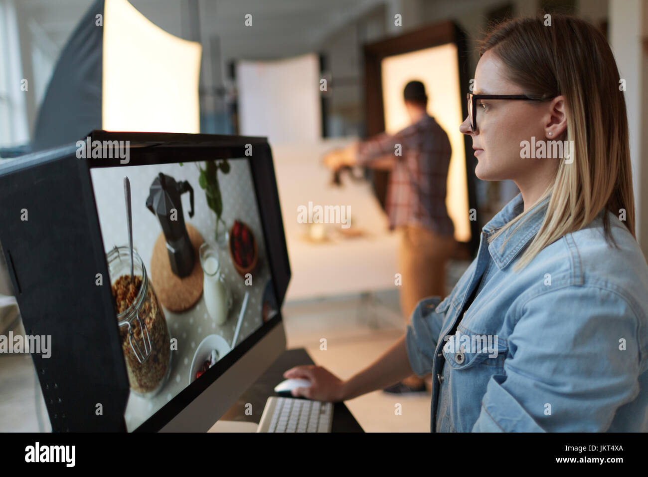 Food designer concentrating on work in front of computer monitor Stock ...