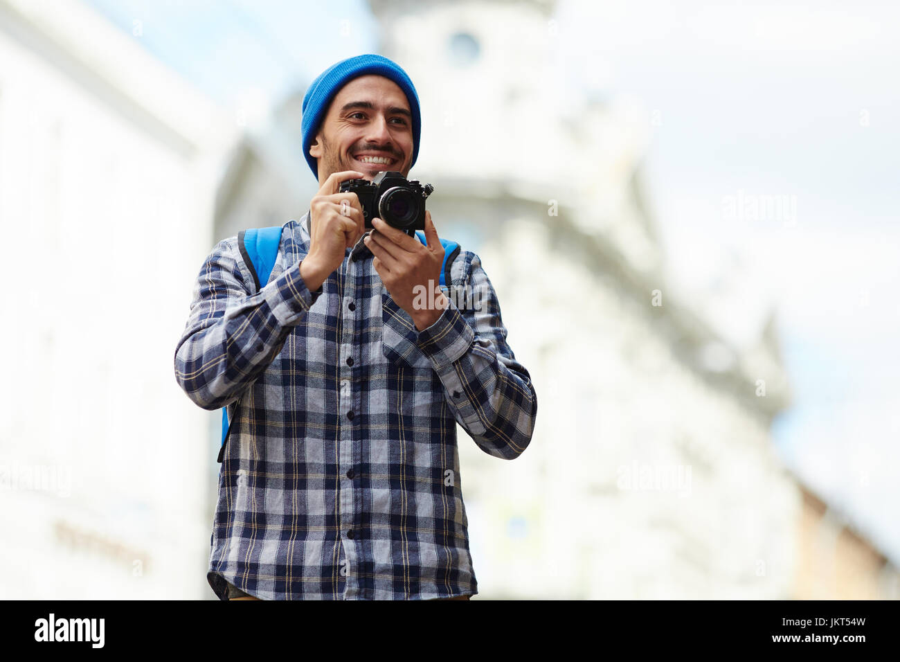 Portrait of modern tourist on solo trip in Europe, young man standing ...