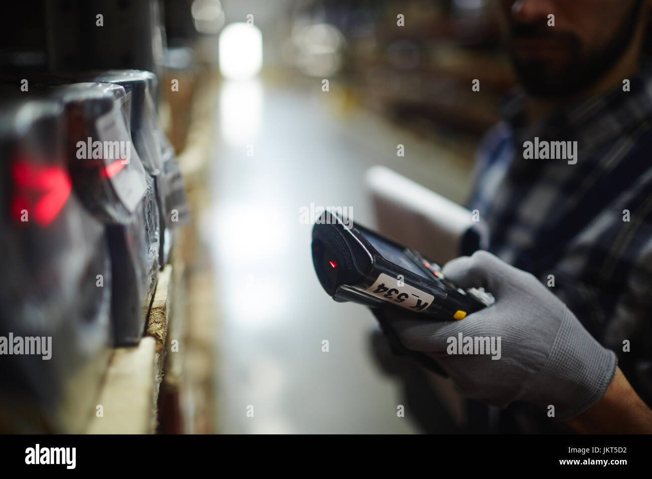 Side view closeup of bar code scanner in hand of unrecognizable ...