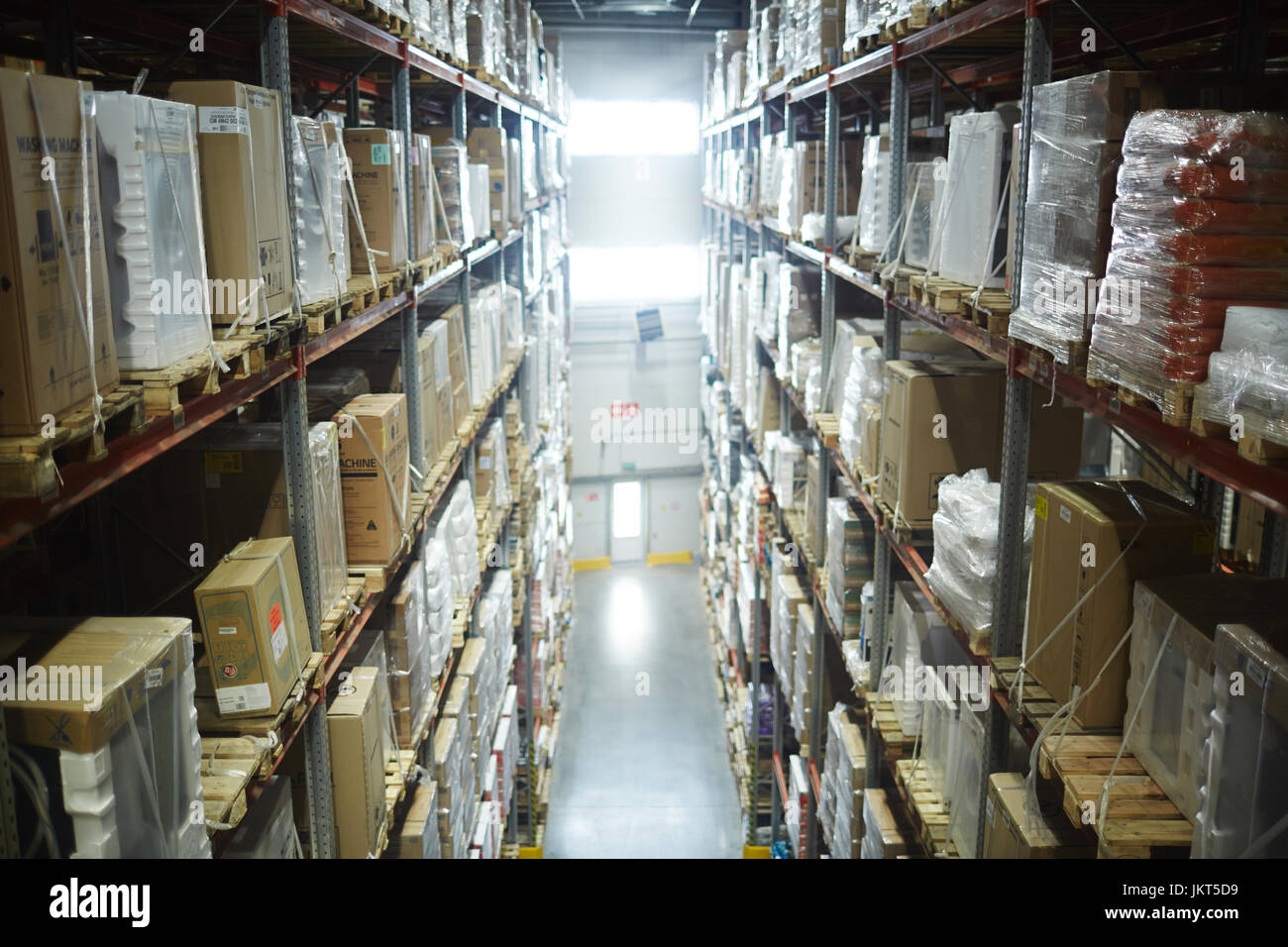 High angle view of warehouse aisle with rows of tall shelves full of ...