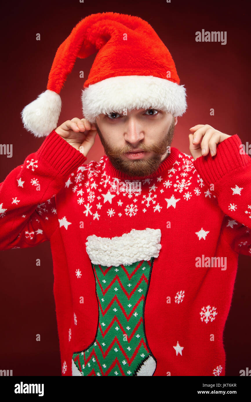 Surprised christmas man wearing a santa hat Stock Photo - Alamy