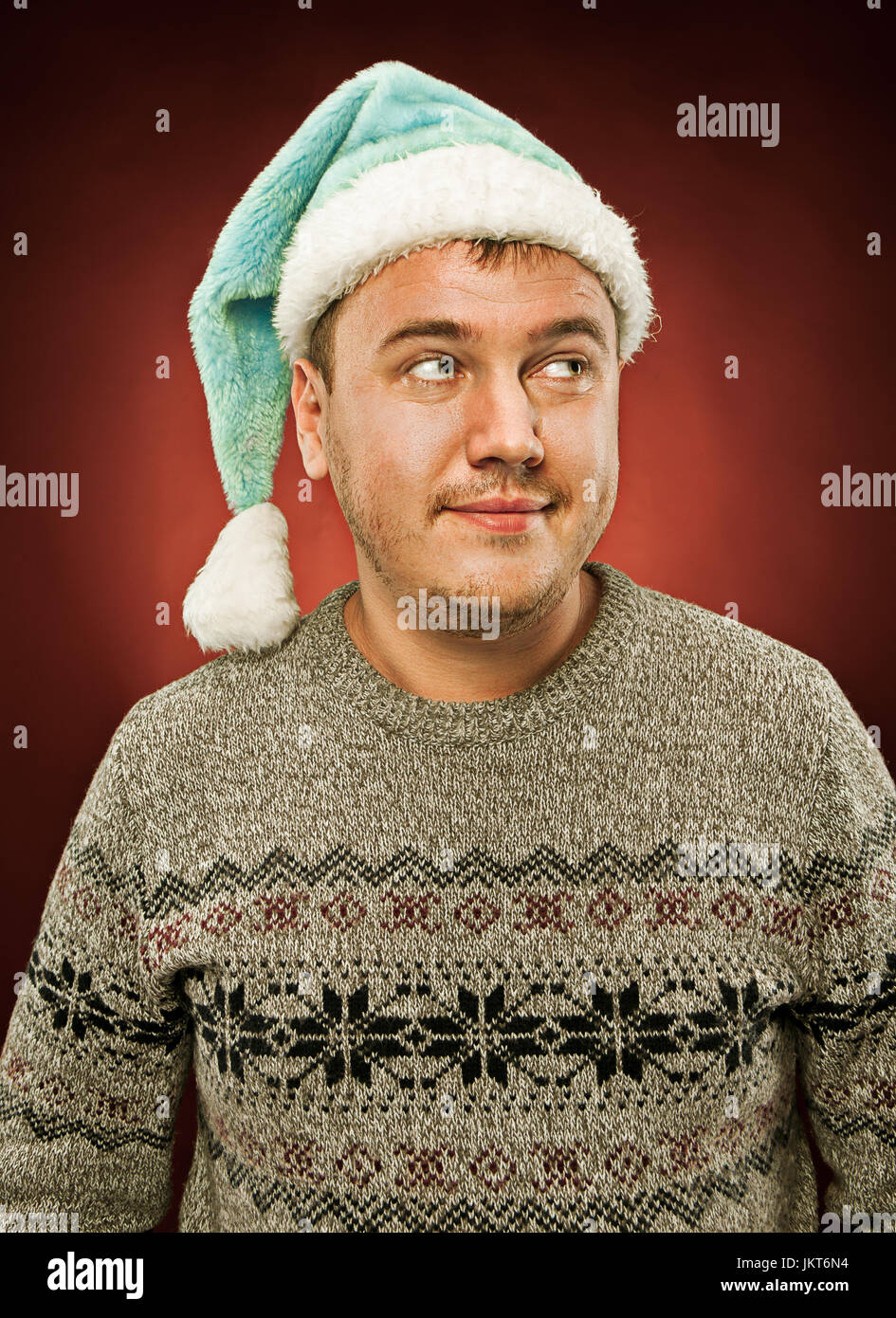 Surprised christmas man wearing a santa hat Stock Photo - Alamy