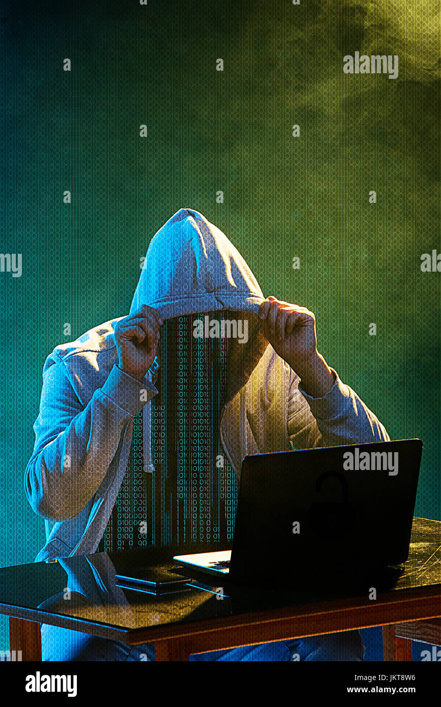Hooded computer hacker stealing information with laptop Stock Photo - Alamy