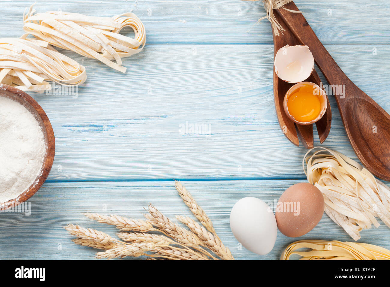 Pasta cooking ingredients on wooden kitchen table. Top view with space ...