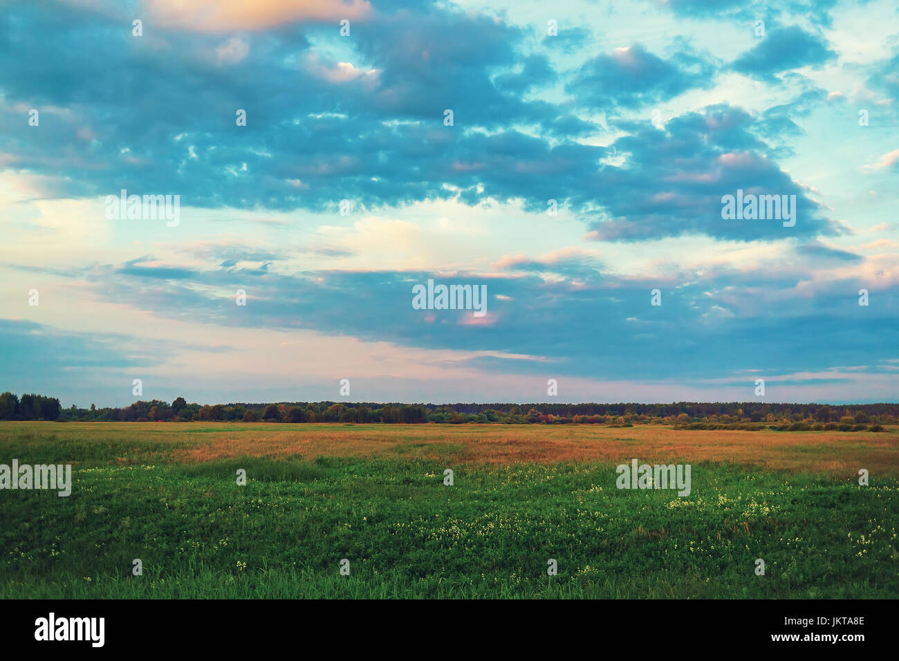 Evening in the countryside. Scenic rural landscape. Sky with clouds and ...
