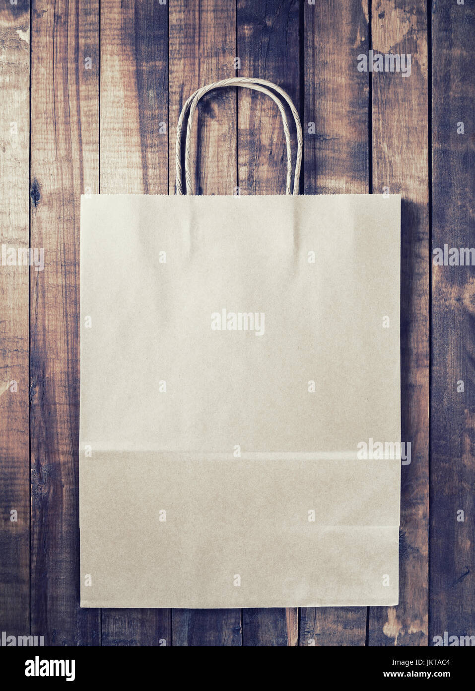 Photo of recycled paper shopping bag on vintage wood table background ...