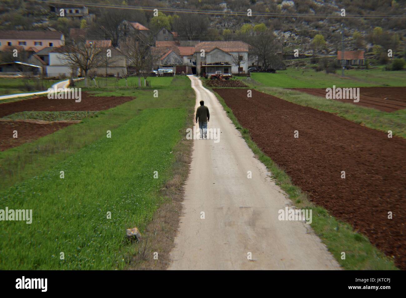 Man walking down the village street Stock Photo - Alamy