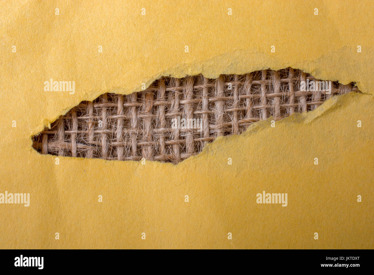 Yellow color torn paper on a linen canvas Stock Photo - Alamy