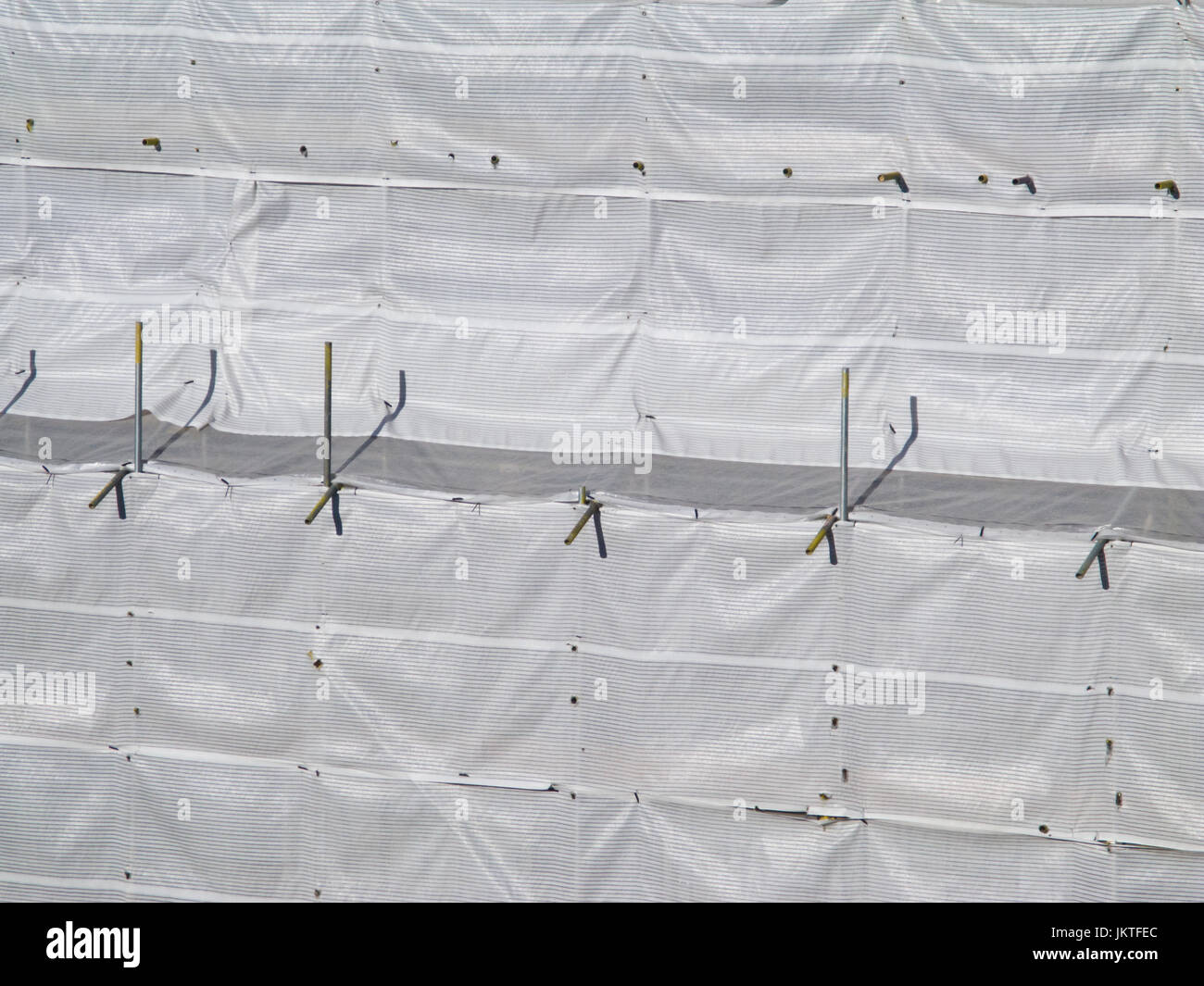 Building under construction, wrapped in white Stock Photo - Alamy