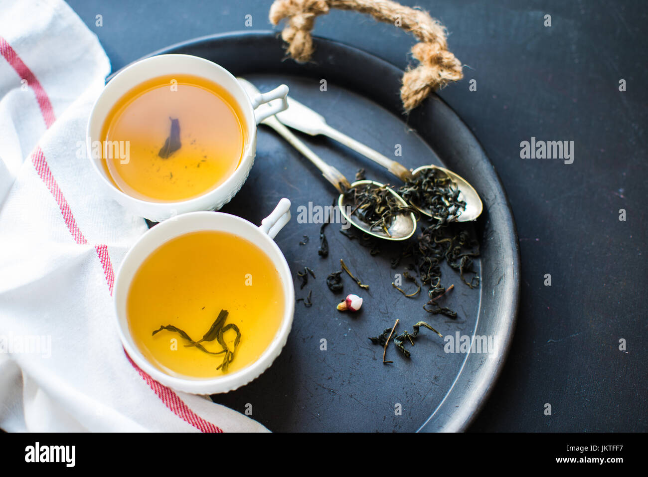 Cup of green tea and peach blossom on dark rustic table as a spring ...