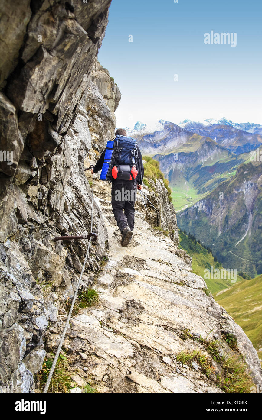 Man walks on dangerous trail in alpine mountains. Alps, Allgau Stock ...