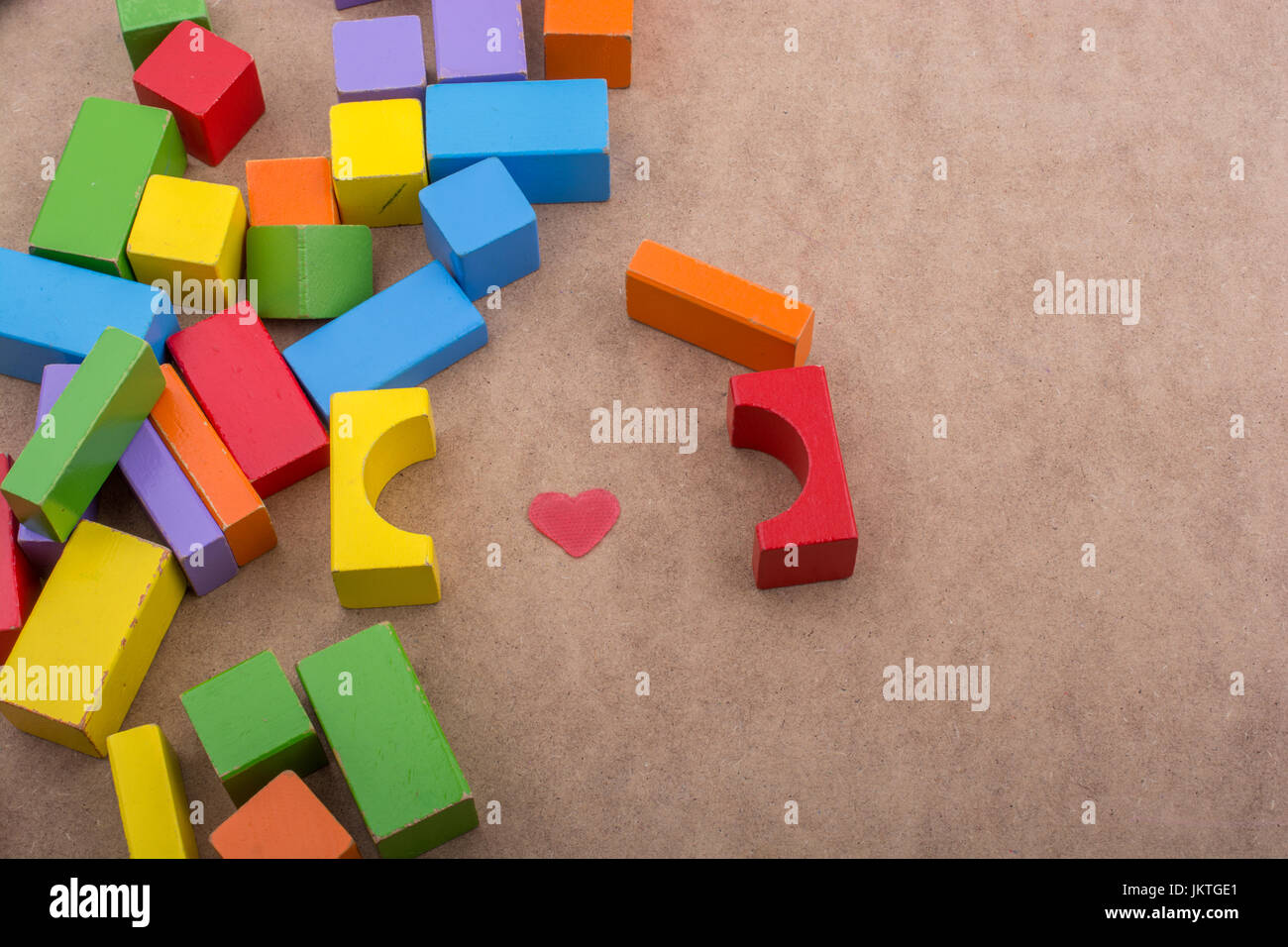 Heart shape placed between building blocks Stock Photo - Alamy