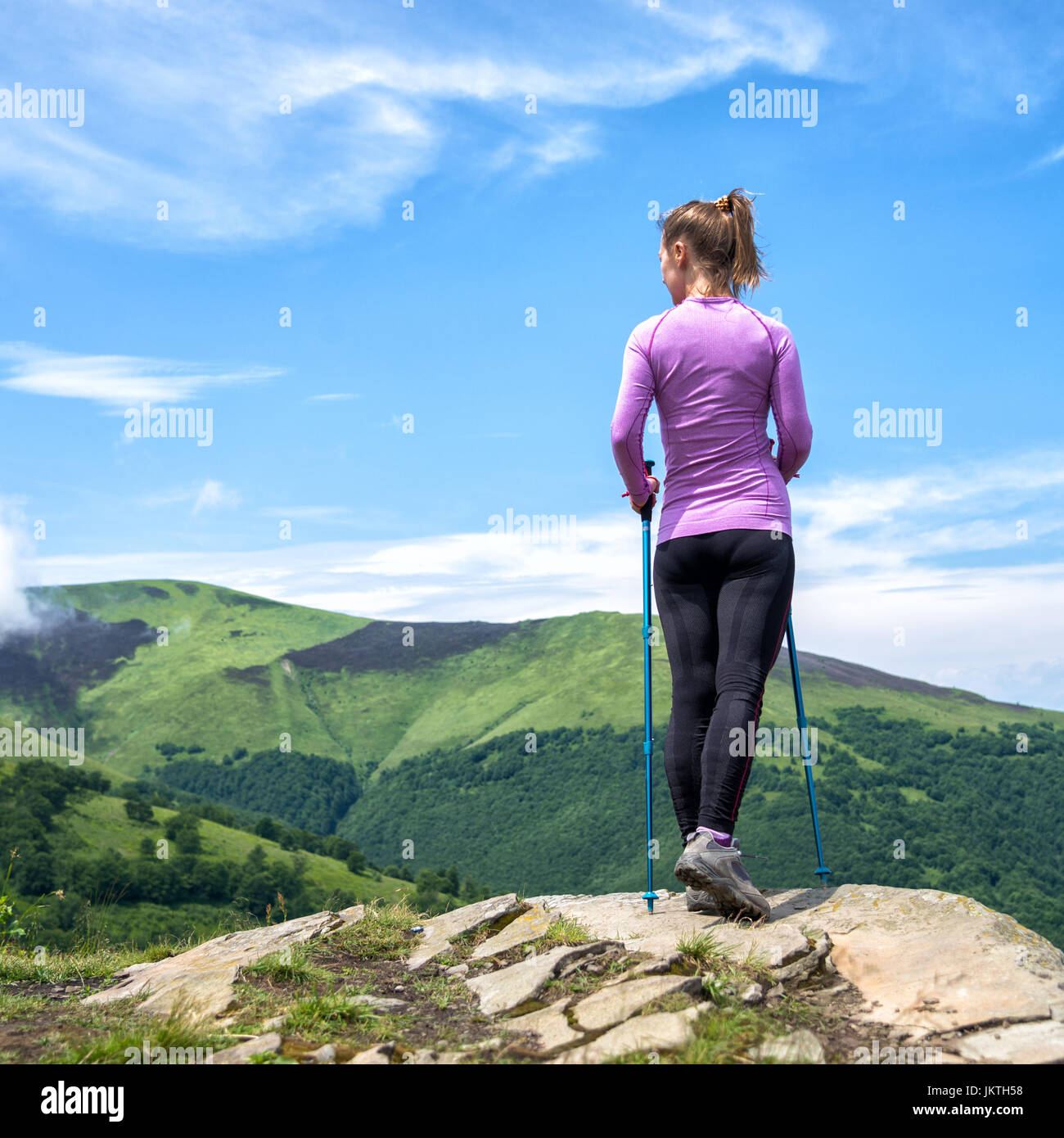 Young woman hiking in the mountains Stock Photo - Alamy