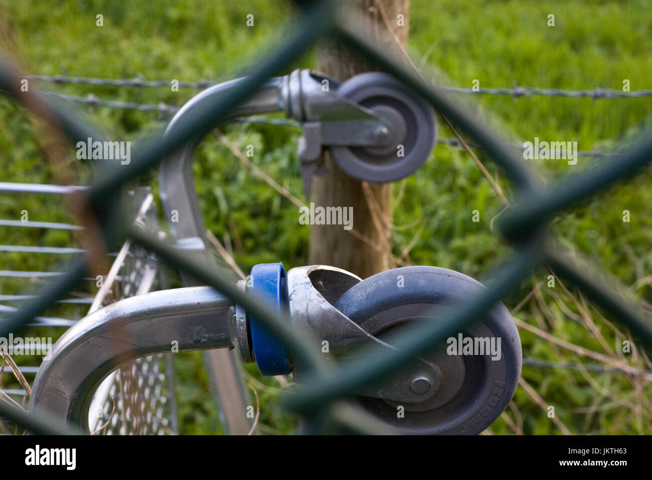 Shopping Trolley detail through fence Stock Photo - Alamy