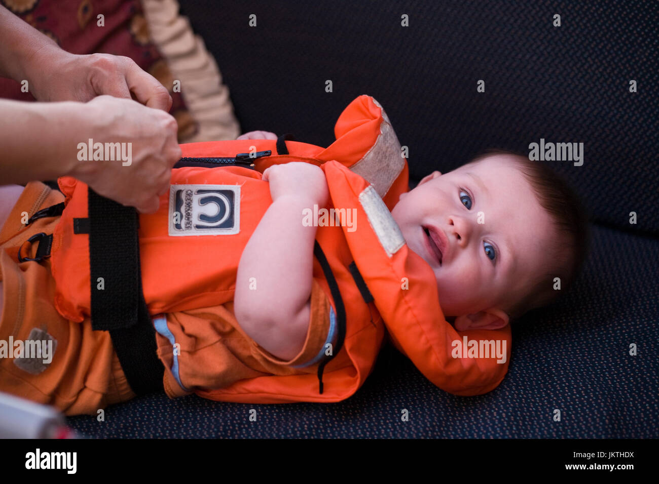 Baby in life jacket Stock Photo - Alamy