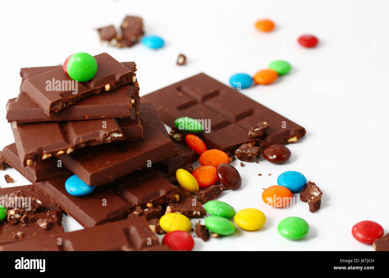 sweet chocolate bar and color candy in white background with space ...