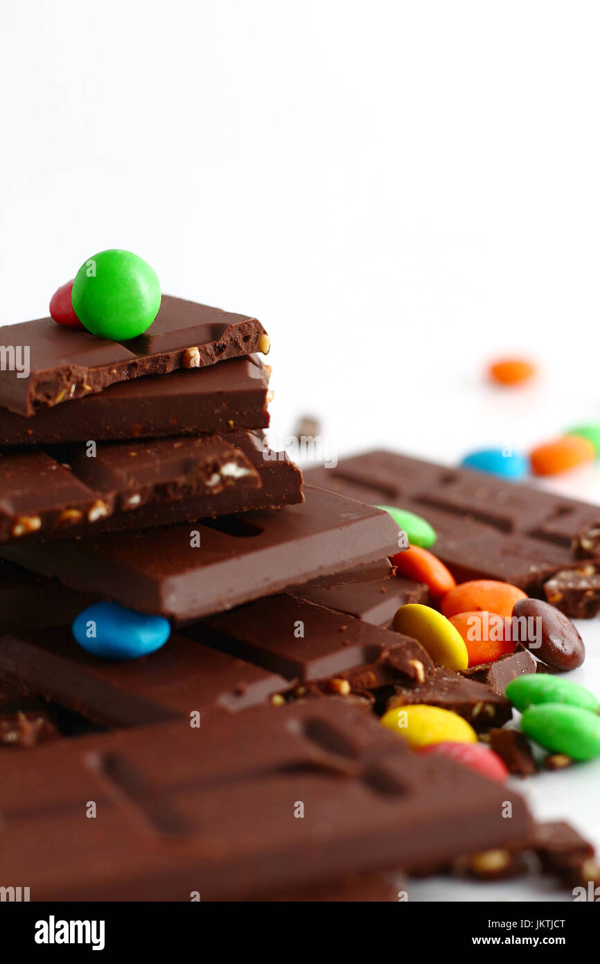 sweet chocolate bar and color candy in white background with space ...
