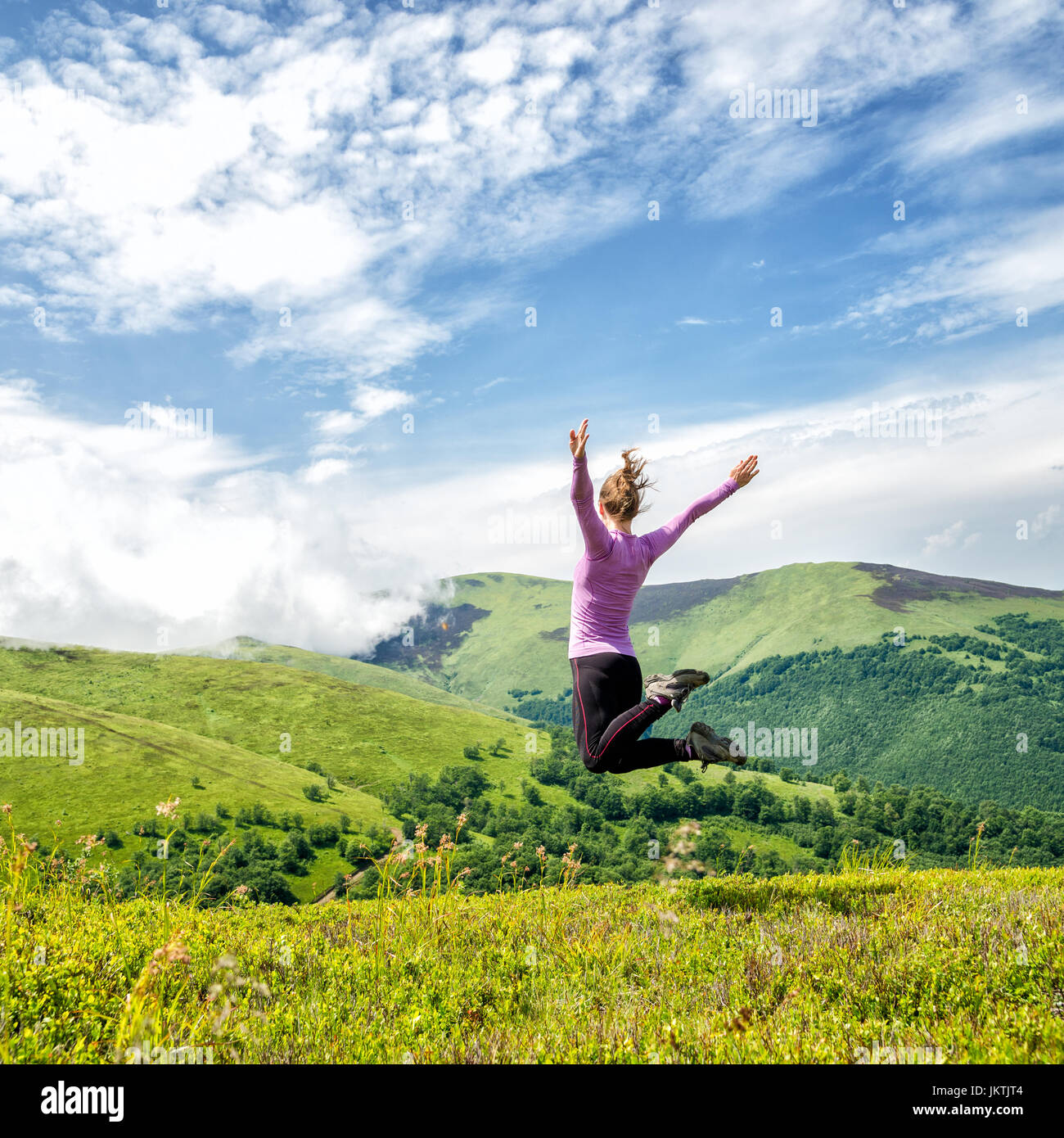 Young woman without backpack jumping in the mountains Stock Photo - Alamy