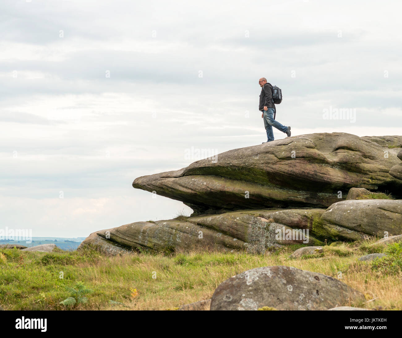 Man walking on Owler Tor, Peak District, UK Stock Photo - Alamy