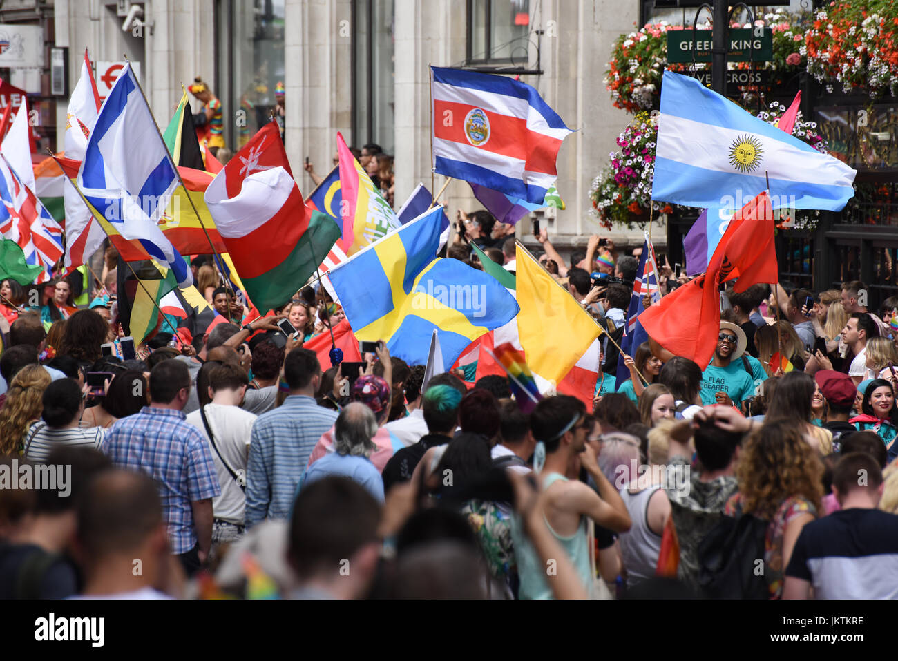 Flag bearers are marching with world flags at the parade in London, UK ...
