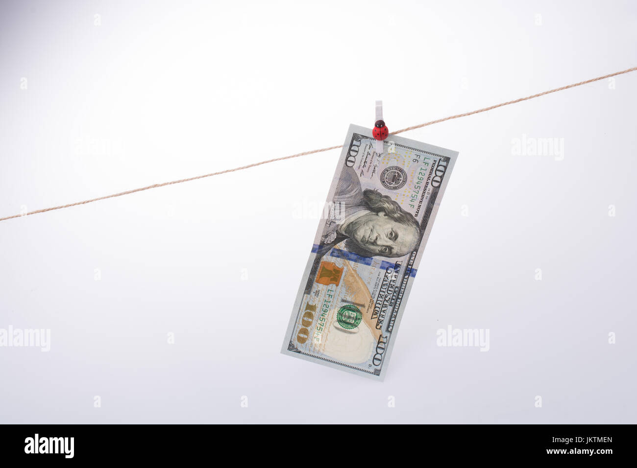 Banknote of US dollar hanging on a linen string Stock Photo - Alamy