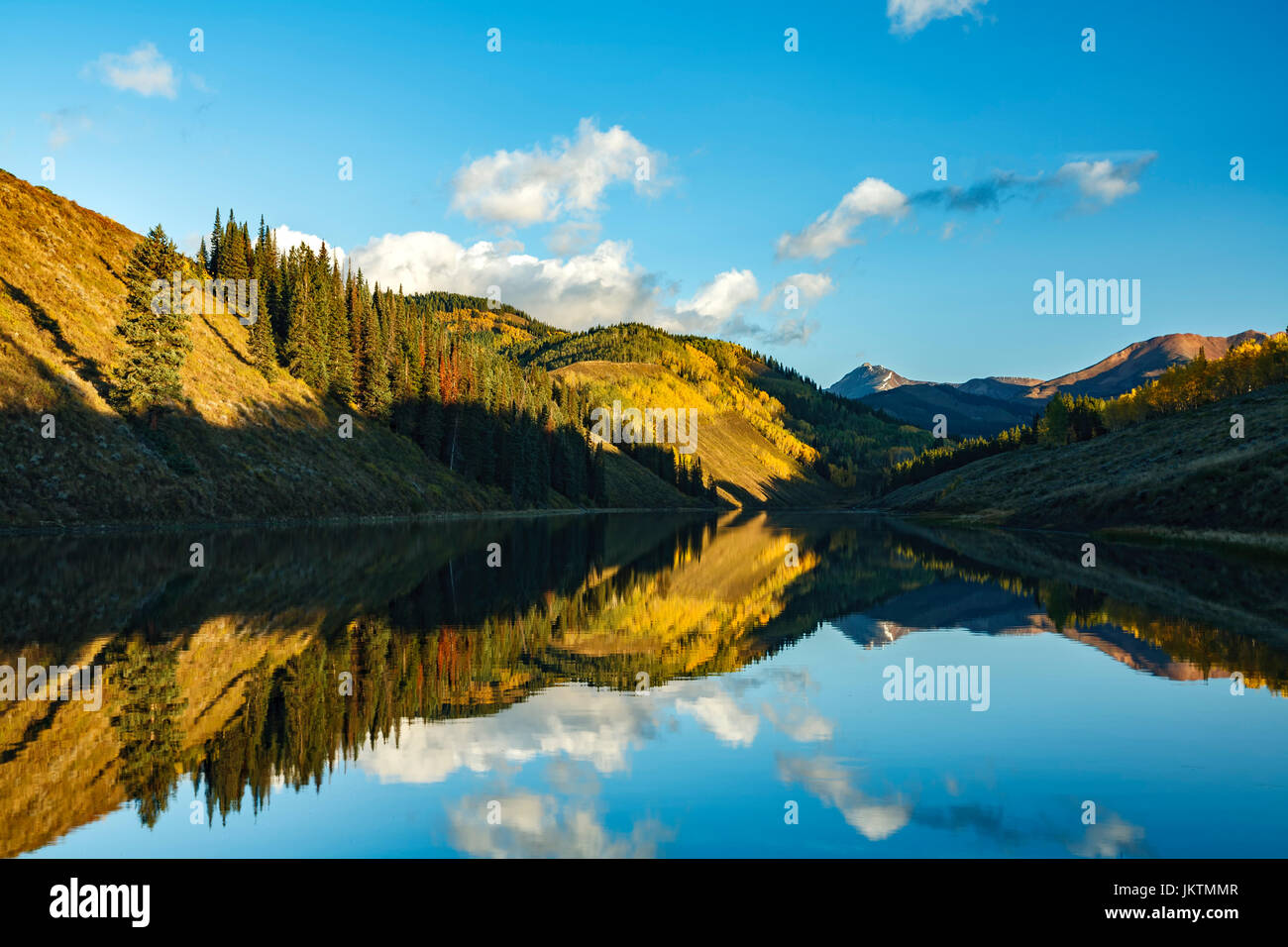 Mountains and clouds reflected on Meridian Lake, Crested Butte ...