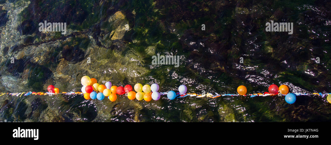 Balloons in shooting range as targets on water Stock Photo - Alamy