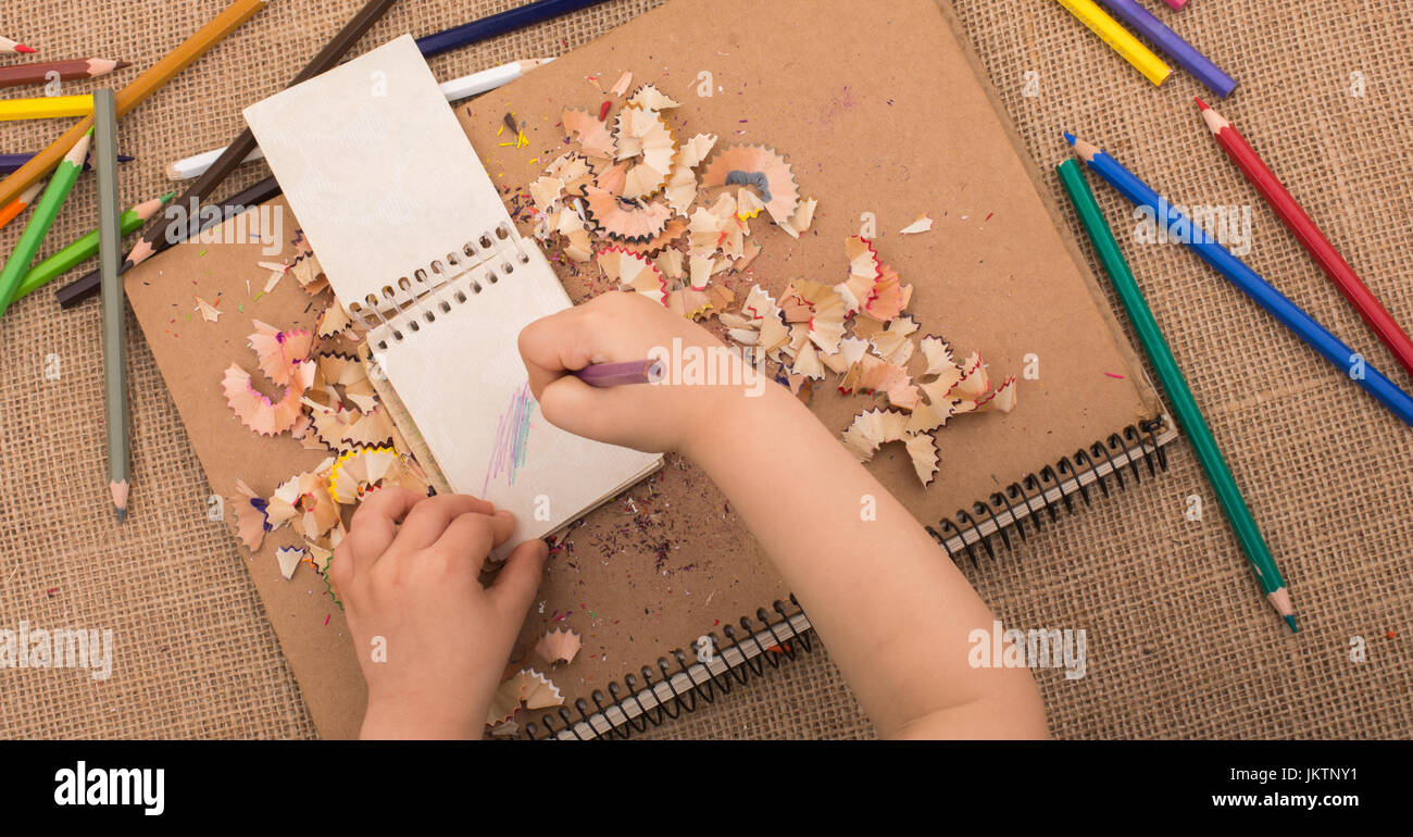 Hand holding a color pencil on spiral notebooks with pencil trash Stock ...