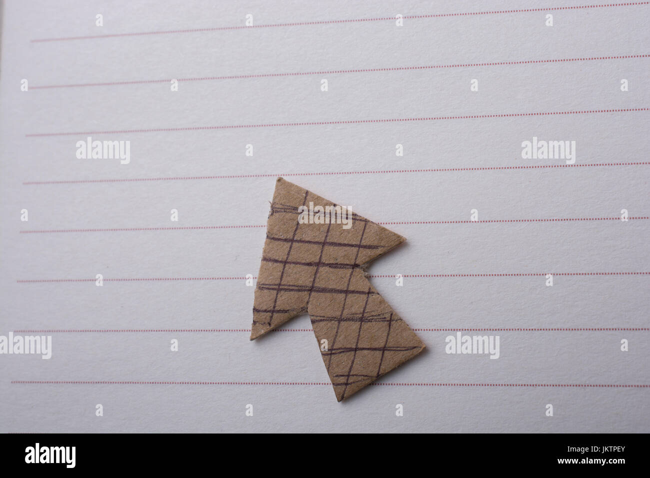 Arrow sign cut out of paper placed on paper on paper Stock Photo - Alamy