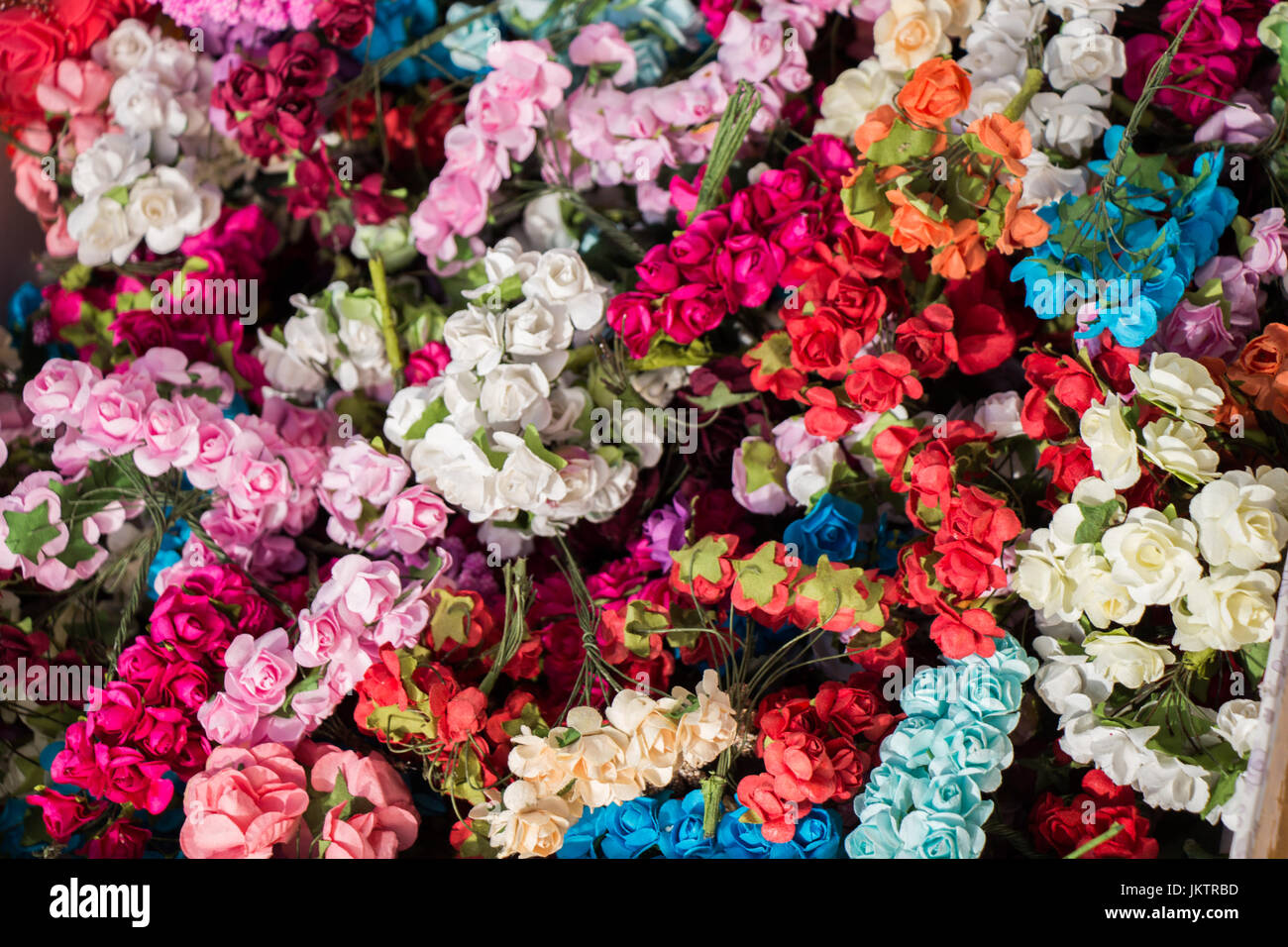 Colorful fake artificial flowers in view Stock Photo - Alamy