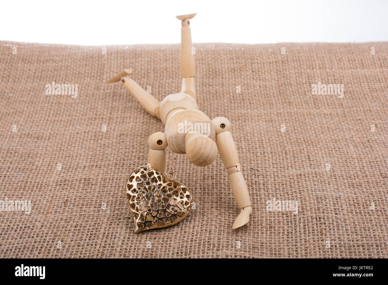 Heart shaped object in the hand of a wooden man toy Stock Photo - Alamy