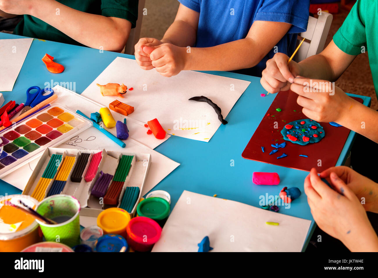 Plasticine modeling clay in children class. Teacher teaches in school ...