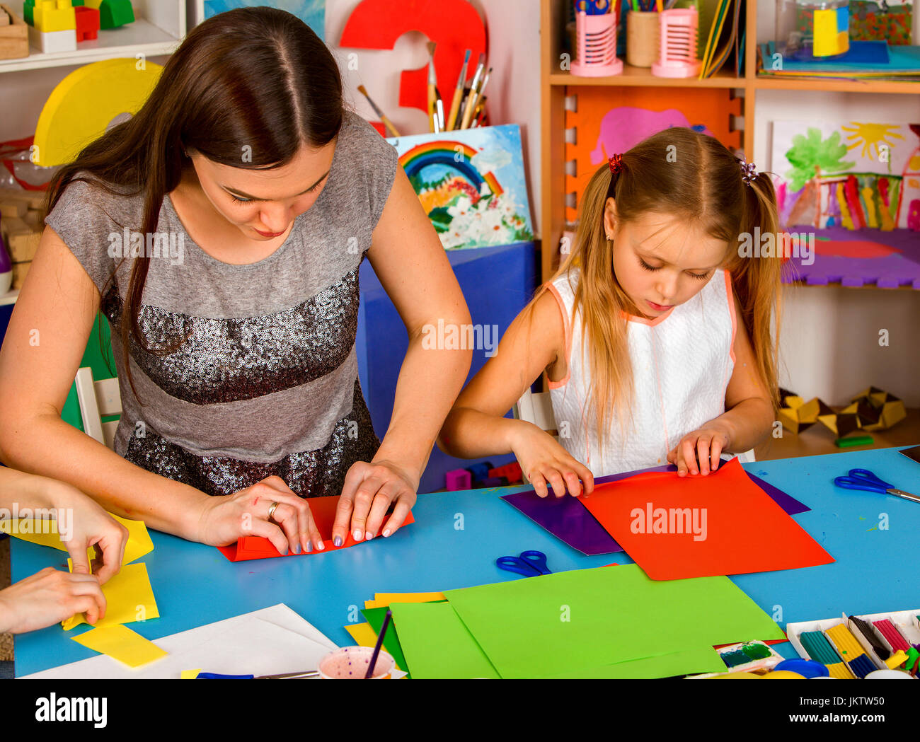 School children with scissors in kids hands cutting paper Stock Photo ...