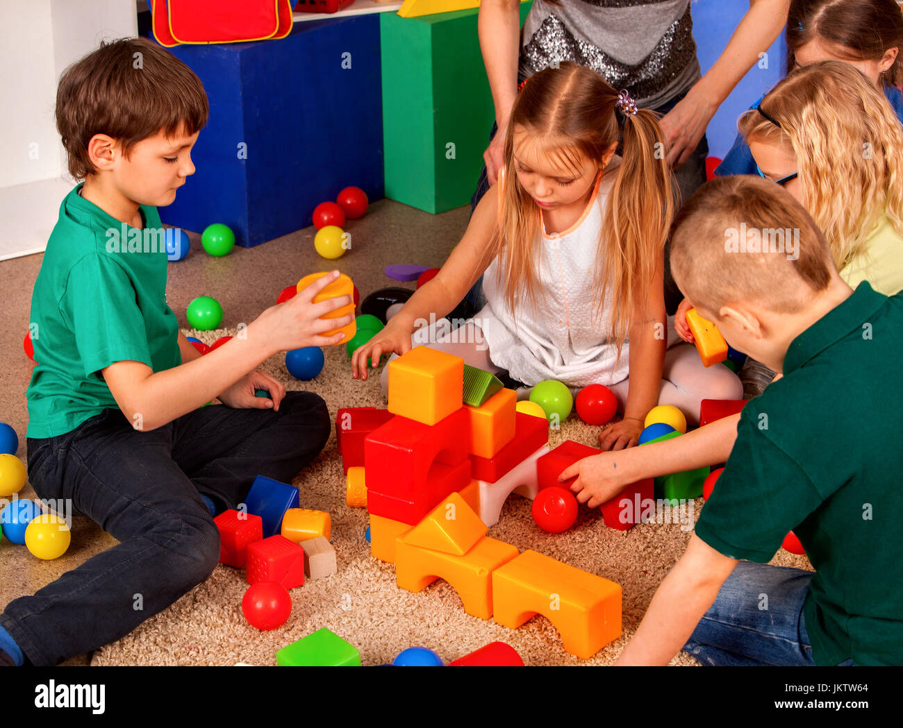 Children building blocks in kindergarten. Group kids playing toy floor ...