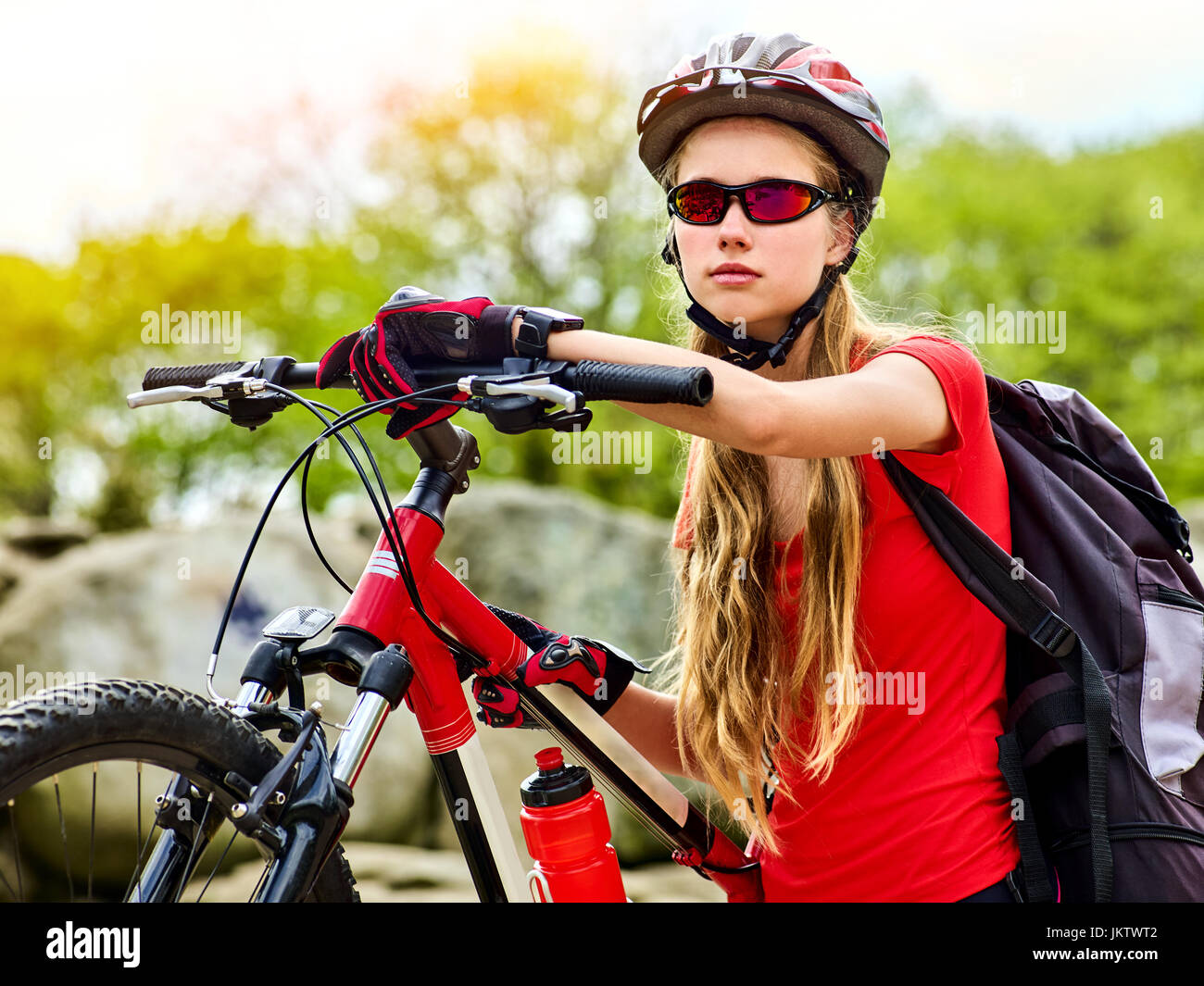 Woman traveling bicycle summer park. Girl with smart watch traveling ...