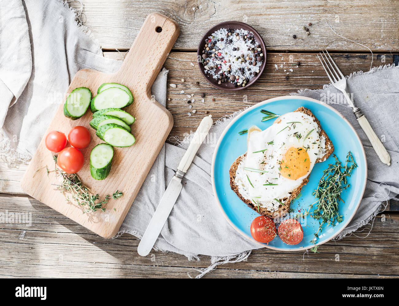 Breakfast set. Whole grain sandwich with fried egg, vegetables and ...