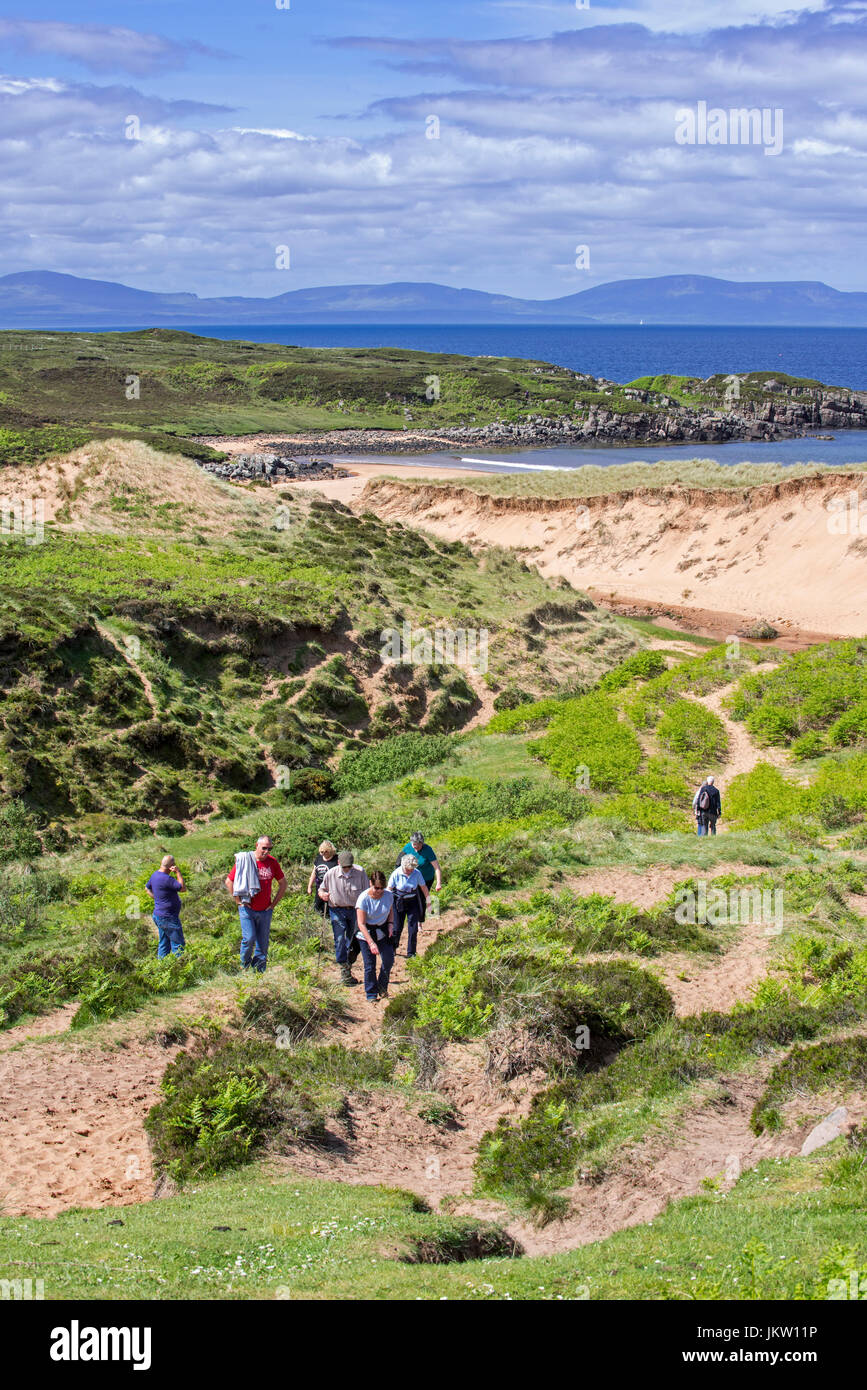 Tourists walking in the dunes and at Red Point / Redpoint, Ross and ...