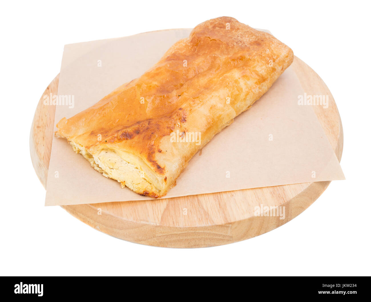 Puff pastry with cottage cheese on baking paper and wooden desk ...