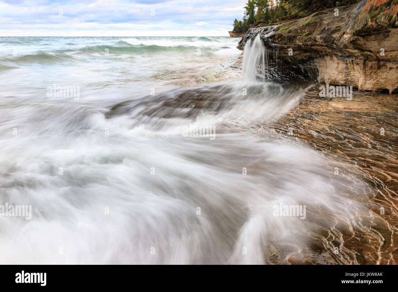 Elliot Falls flows into Lake Superior on Miners Beach at Pictured Rocks ...