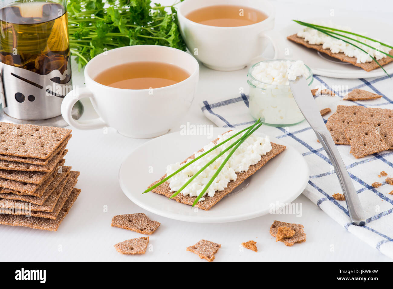 Snack with fresh tea and rye crispy bread (Swedish crackers) with ...