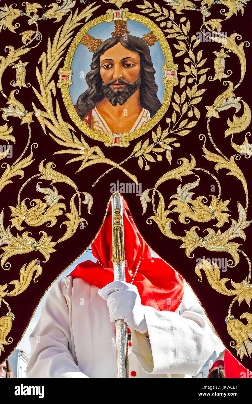 A penitent from the Our Gracious Father Jesus holds the brotherhood ...